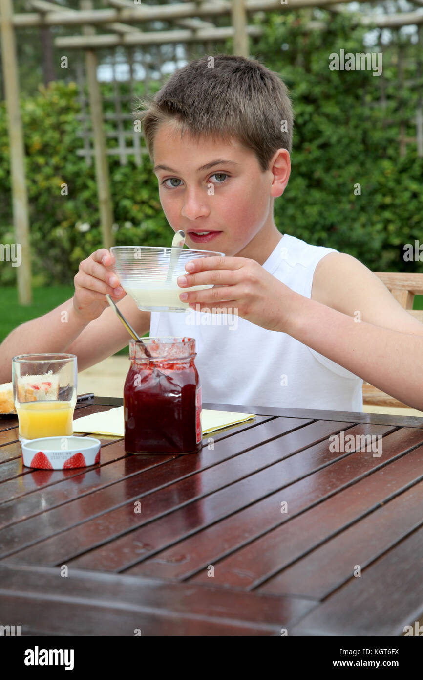 Portrait of young boy having breakfast Stock Photo - Alamy