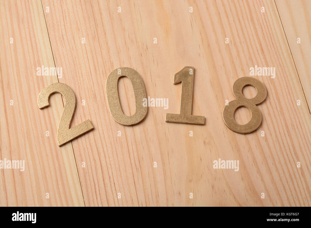 New year two thousand and eighteen in golden wood letters on wooden ...