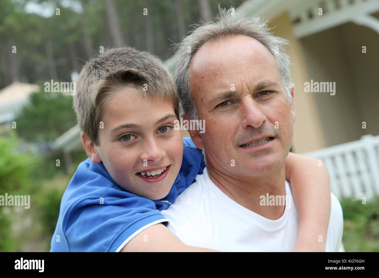 Portrait of man carrying child on his back Stock Photo - Alamy