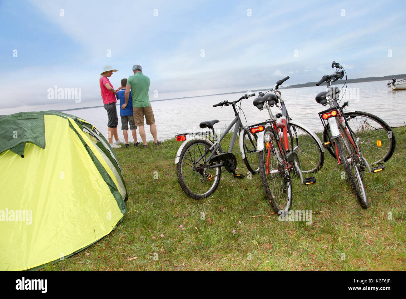 Family camping by a lake Stock Photo - Alamy