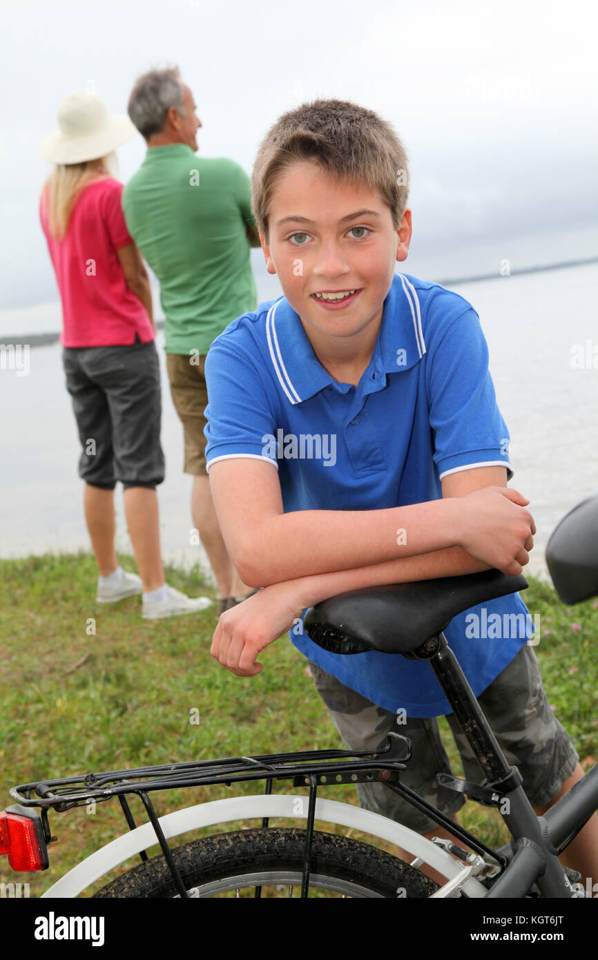 Portrait of young boy leaning on bicycle Stock Photo - Alamy