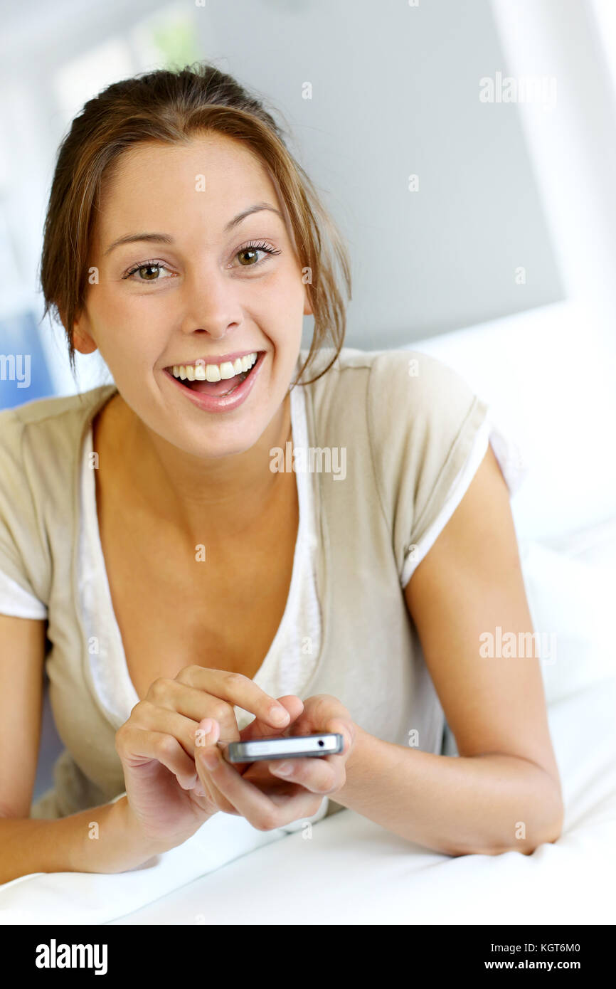 Young woman sending short message with telephone Stock Photo - Alamy