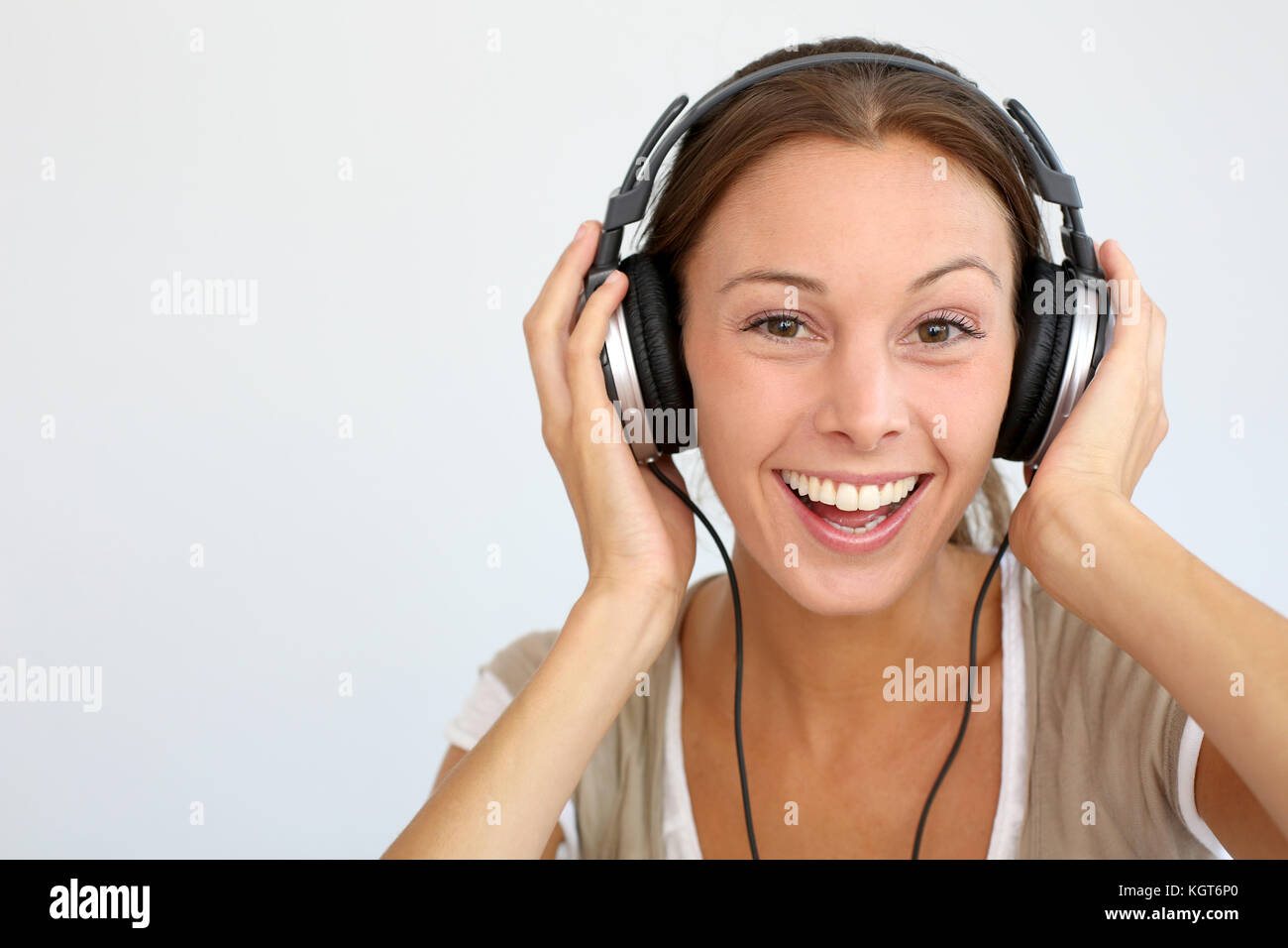 Cheerful woman with headphones, isolated Stock Photo - Alamy