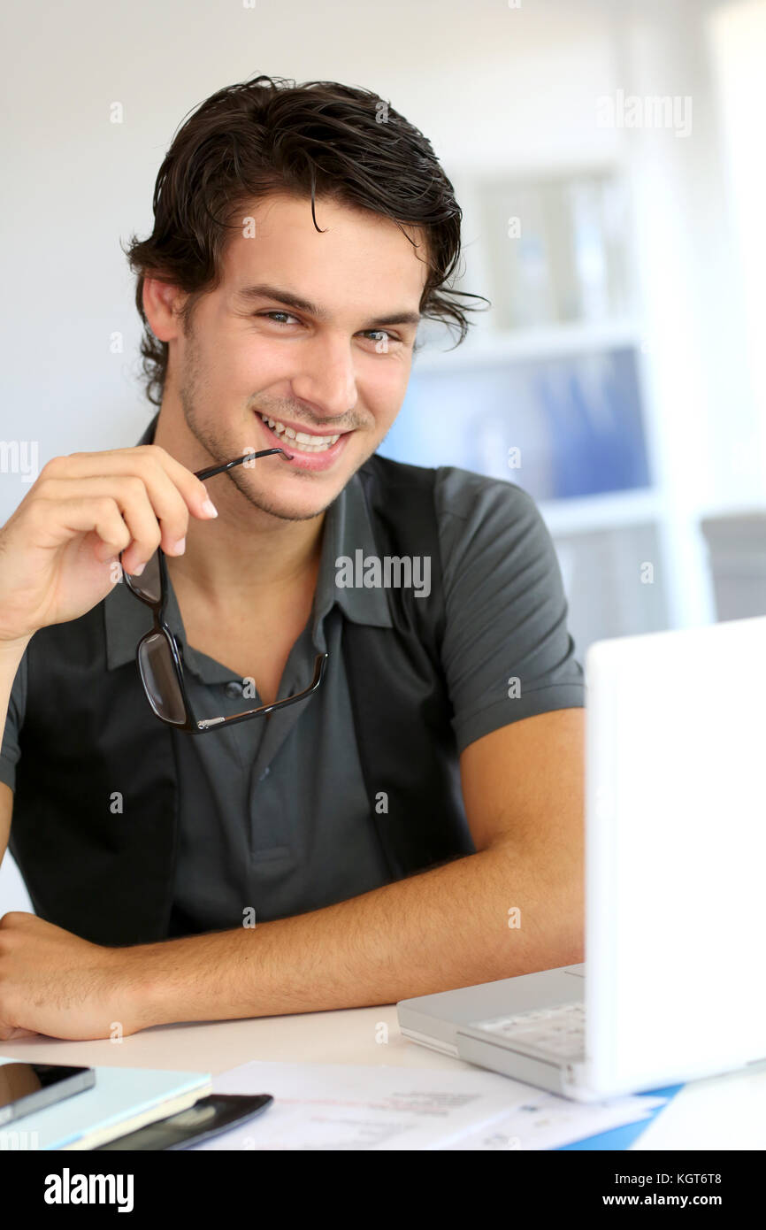 Portrait of young man working in office Stock Photo - Alamy