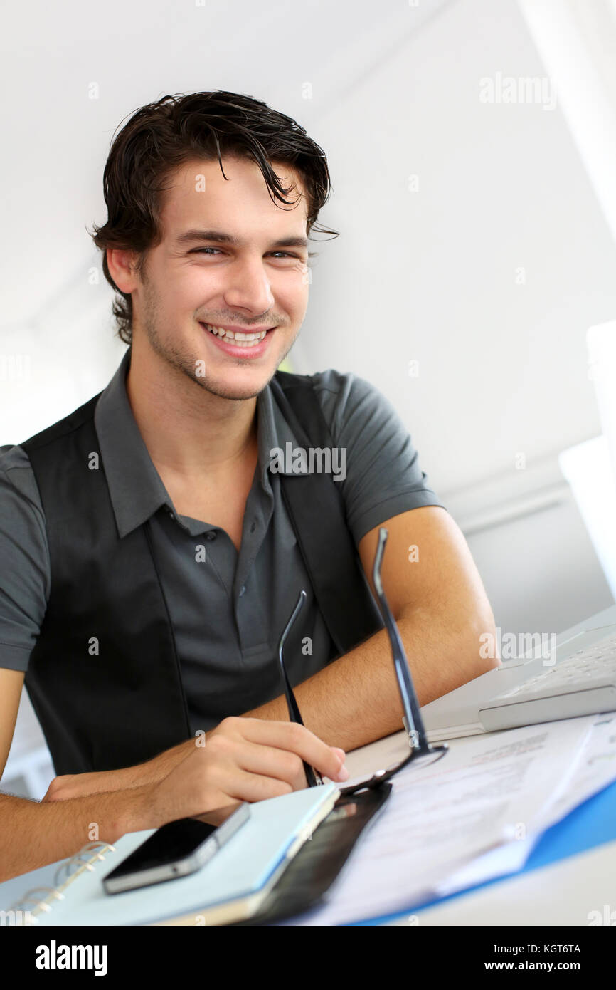 Portrait of young man working in office Stock Photo - Alamy