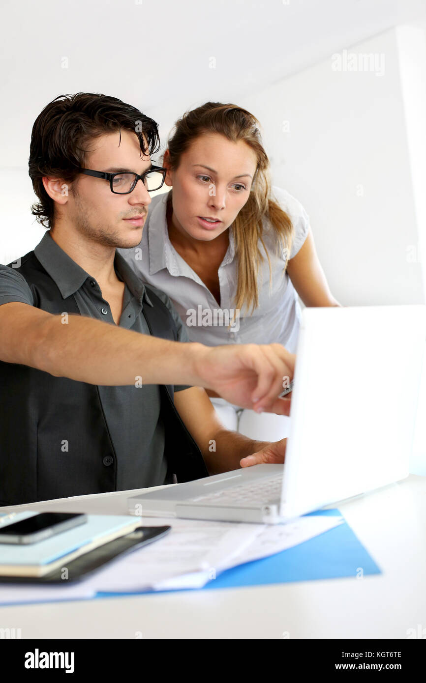 Co-workers in office discussing project Stock Photo - Alamy