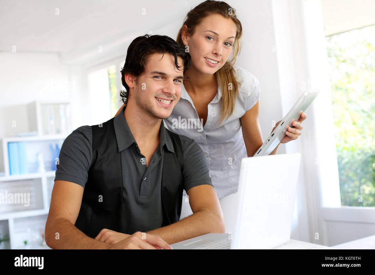 Co-workers in office discussing project Stock Photo - Alamy