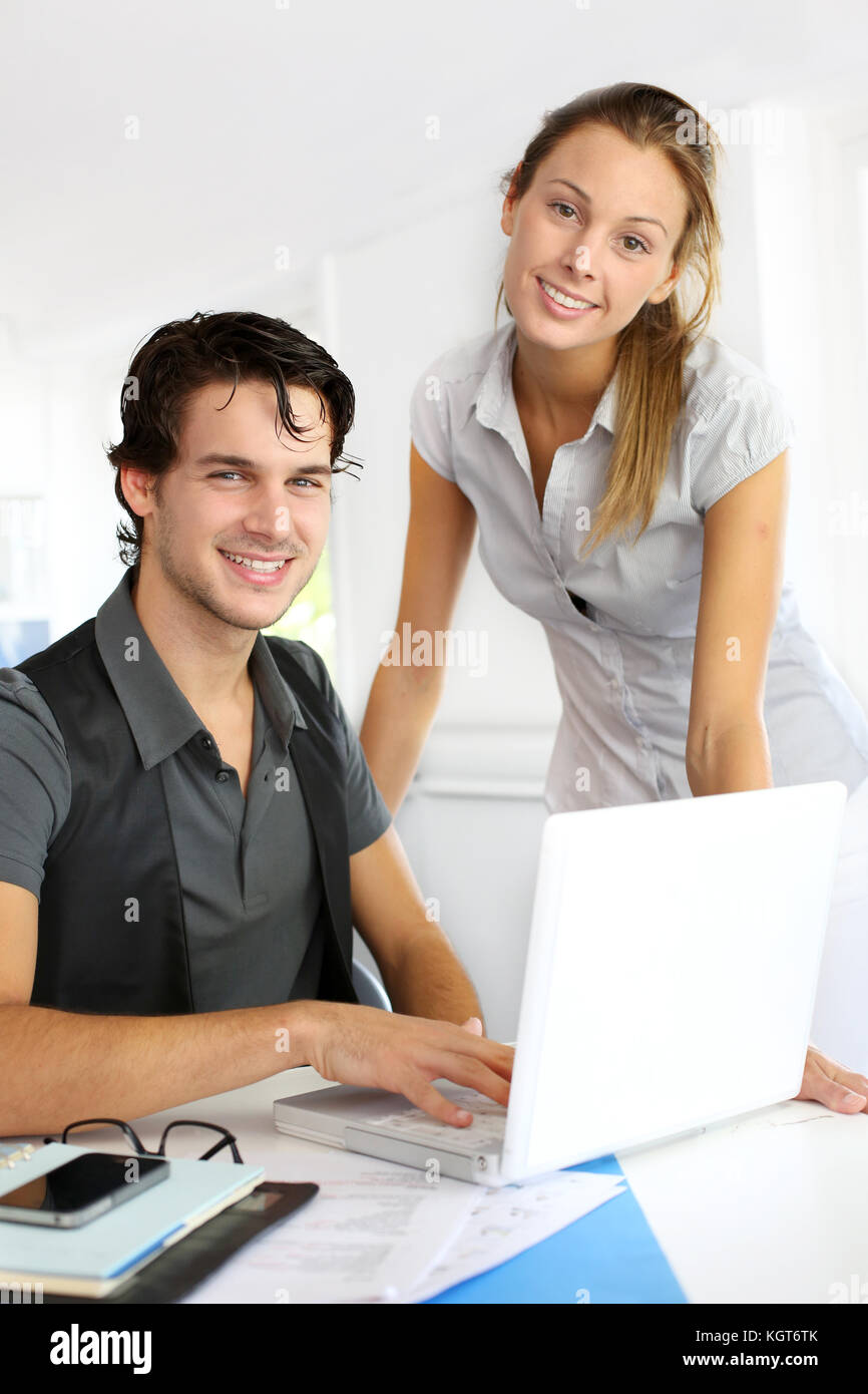 Co-workers in office discussing project Stock Photo - Alamy