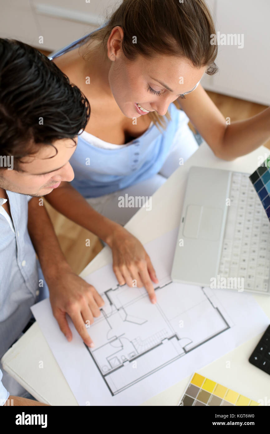 Upper view of couple looking at blueprint Stock Photo - Alamy