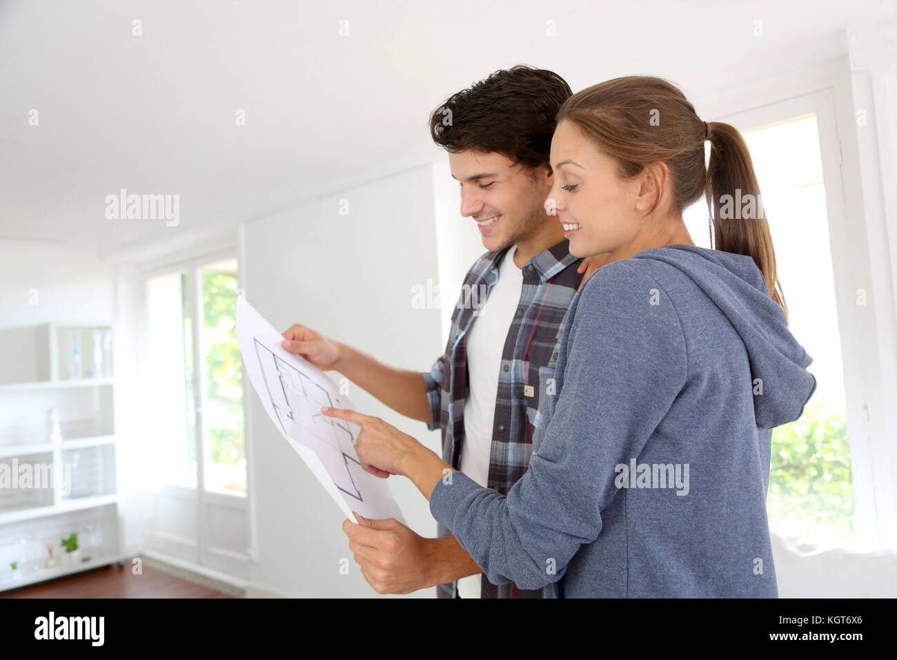 New property owners looking at home blueprint Stock Photo - Alamy