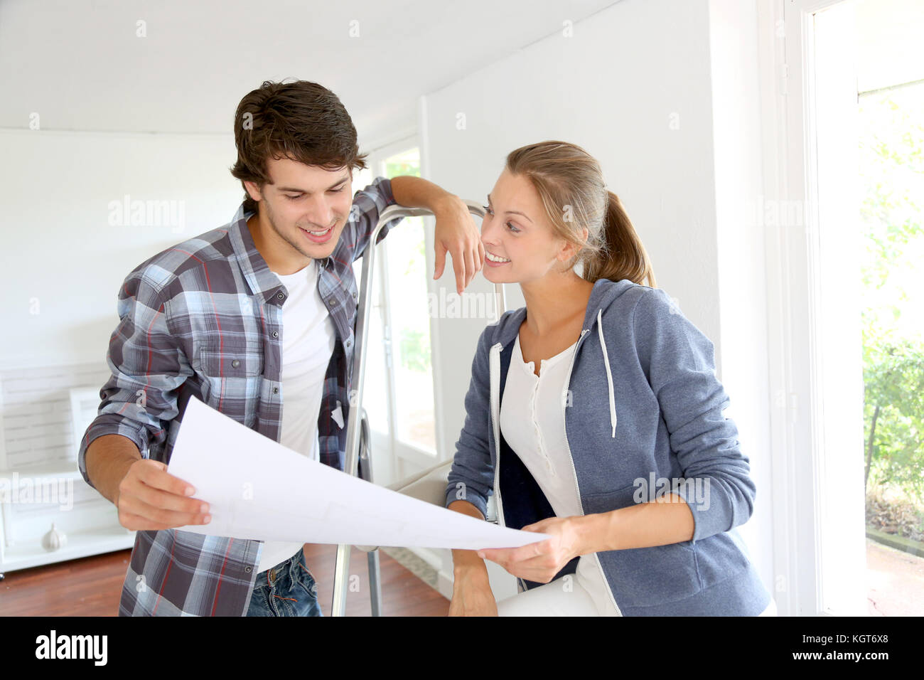 New property owners looking at home blueprint Stock Photo - Alamy