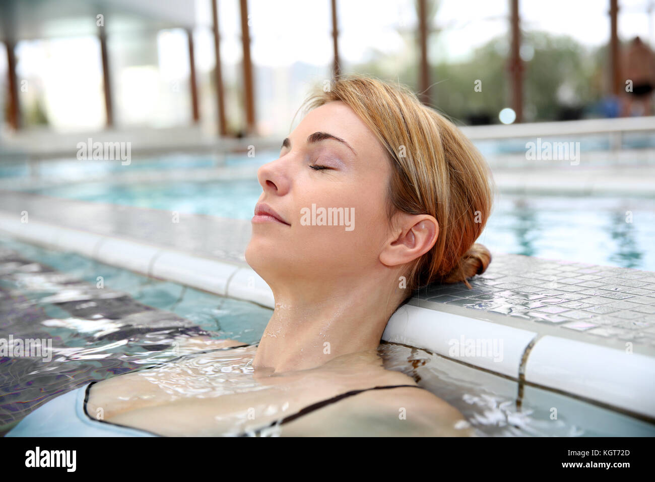 Woman relaxing in swimming-pool of spa resort Stock Photo - Alamy