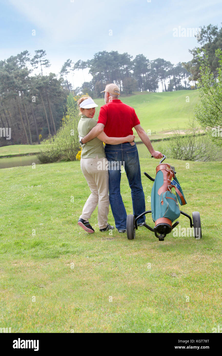Senior people on golf course Stock Photo - Alamy