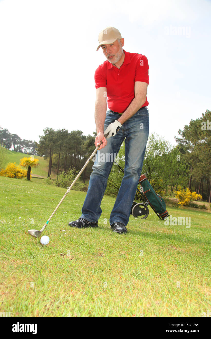 Senior man standing on golf course Stock Photo - Alamy