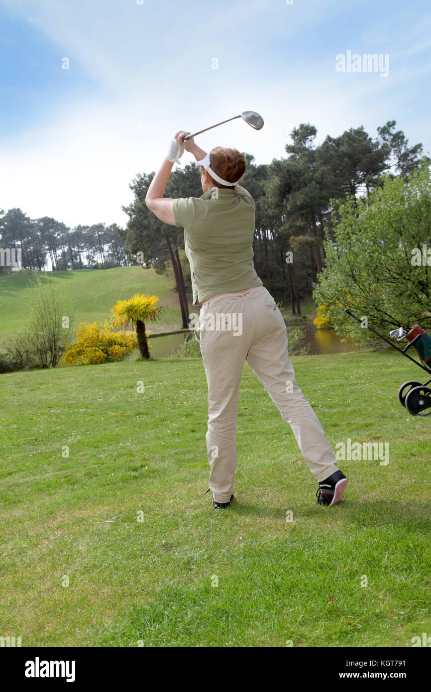 Senior woman playing on golf course Stock Photo - Alamy