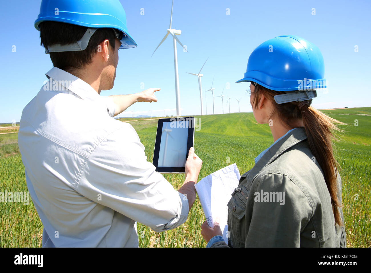 Engineers using tablet on wind turbine site Stock Photo - Alamy