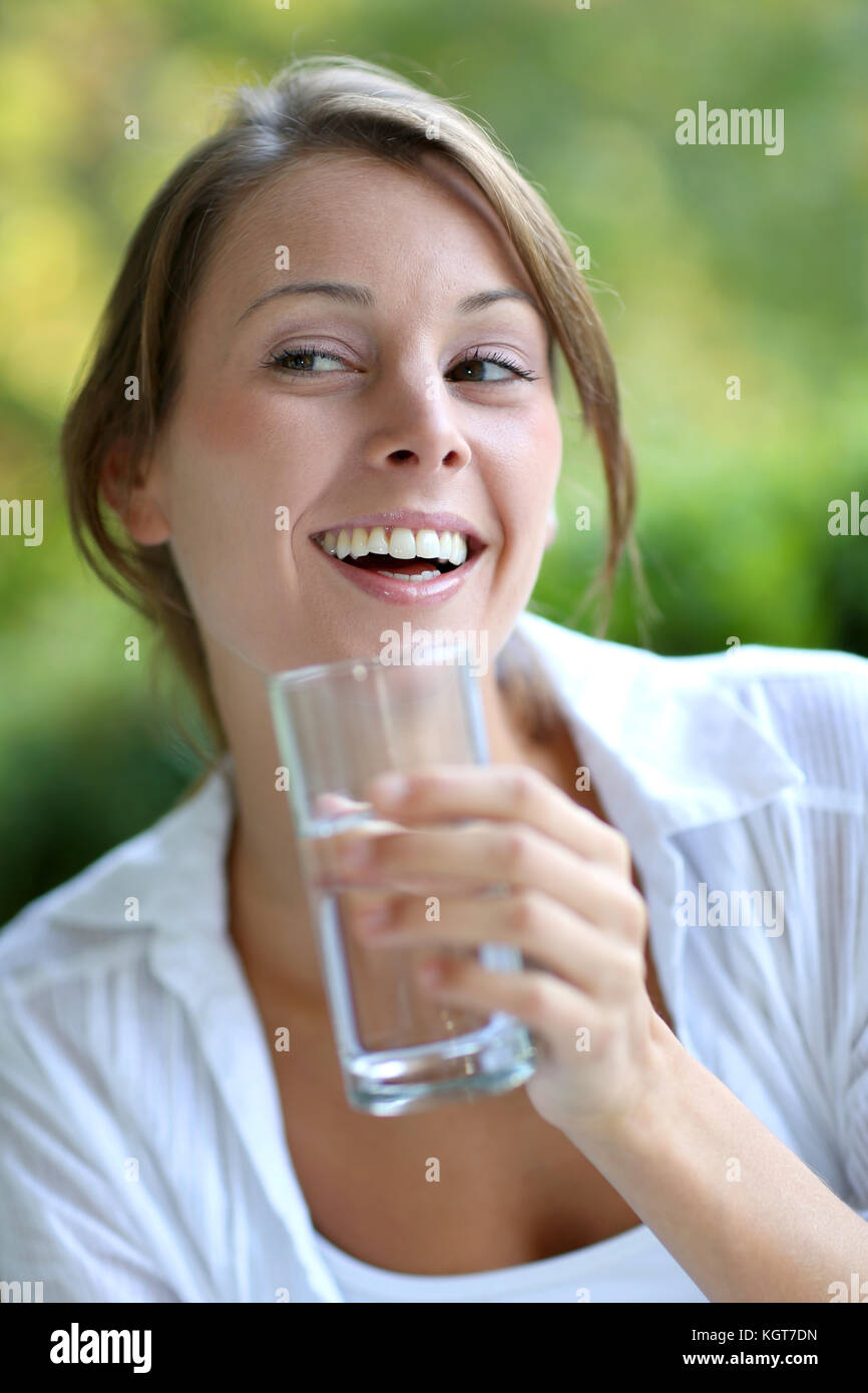 Smiling woman drinking fresh water from glass Stock Photo - Alamy