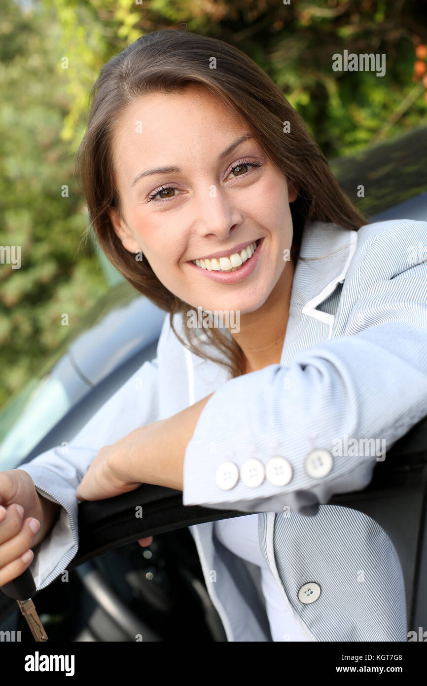 Happy young driver standing by car Stock Photo - Alamy