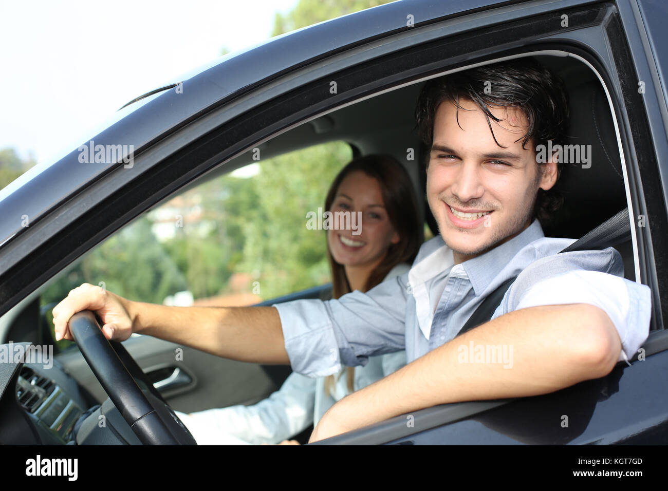 Cheerful couple driving car Stock Photo - Alamy