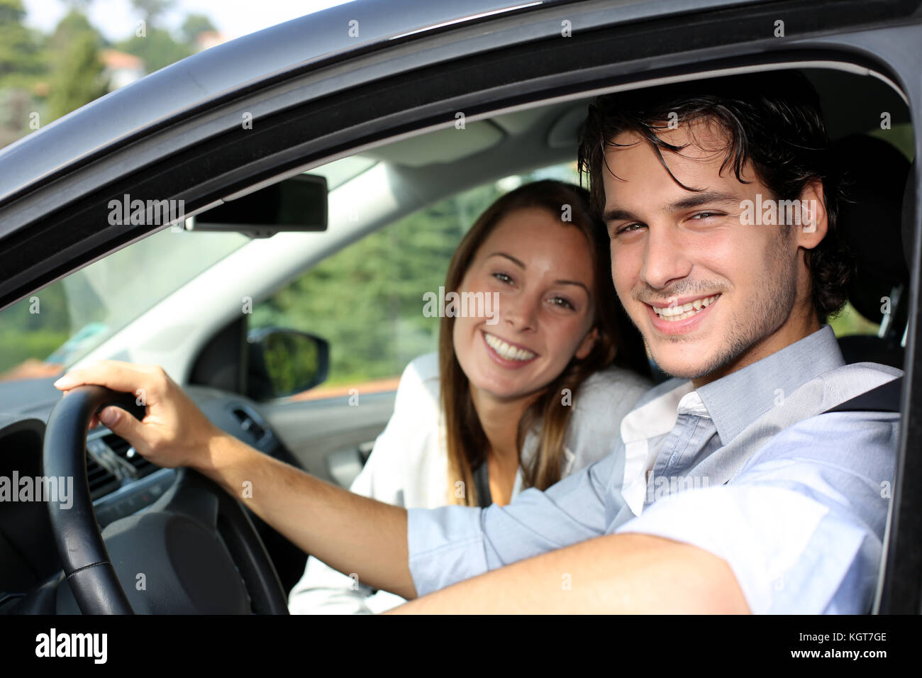 Cheerful couple driving car Stock Photo - Alamy