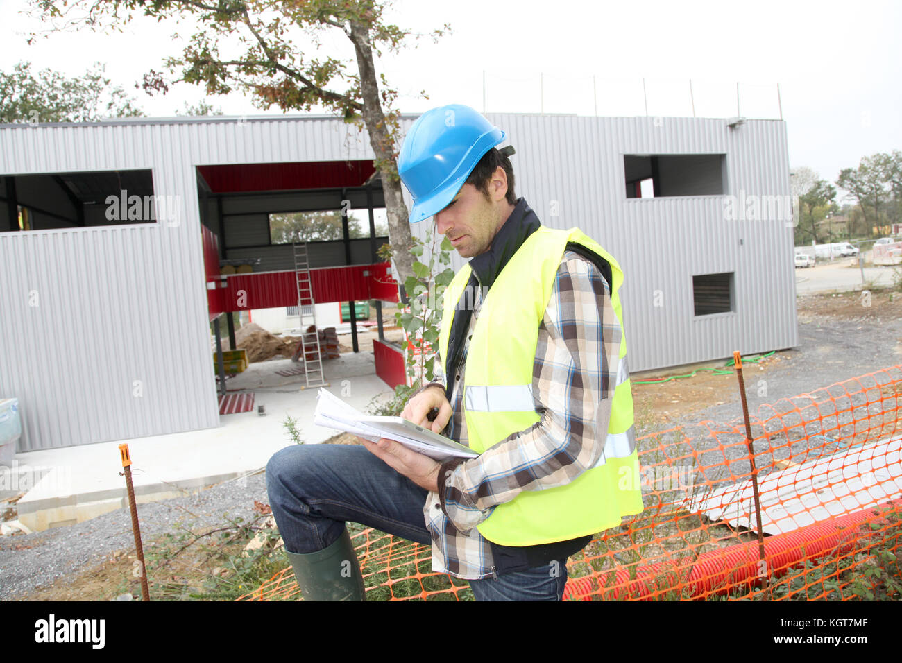 Construction manager using electronic tablet on site Stock Photo - Alamy
