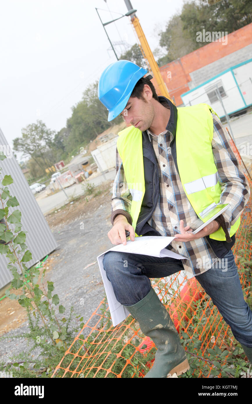 Construction manager using electronic tablet on site Stock Photo - Alamy