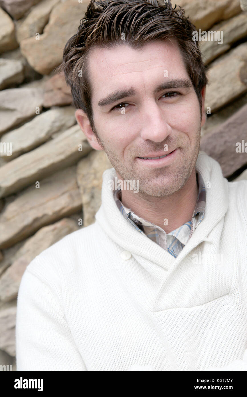 Man standing in front of stone house Stock Photo - Alamy