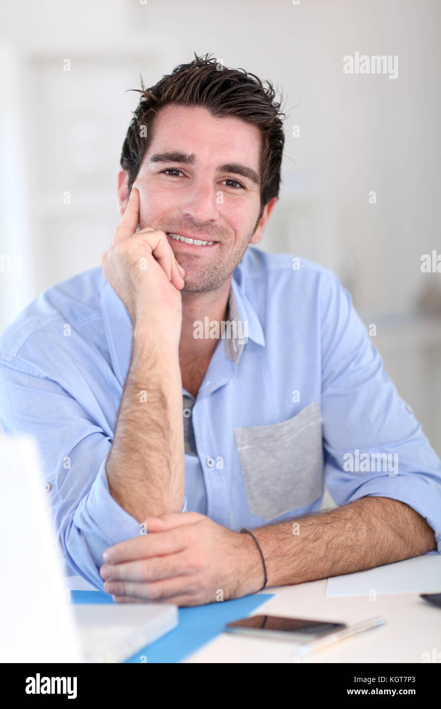 Smiling office worker at work Stock Photo - Alamy