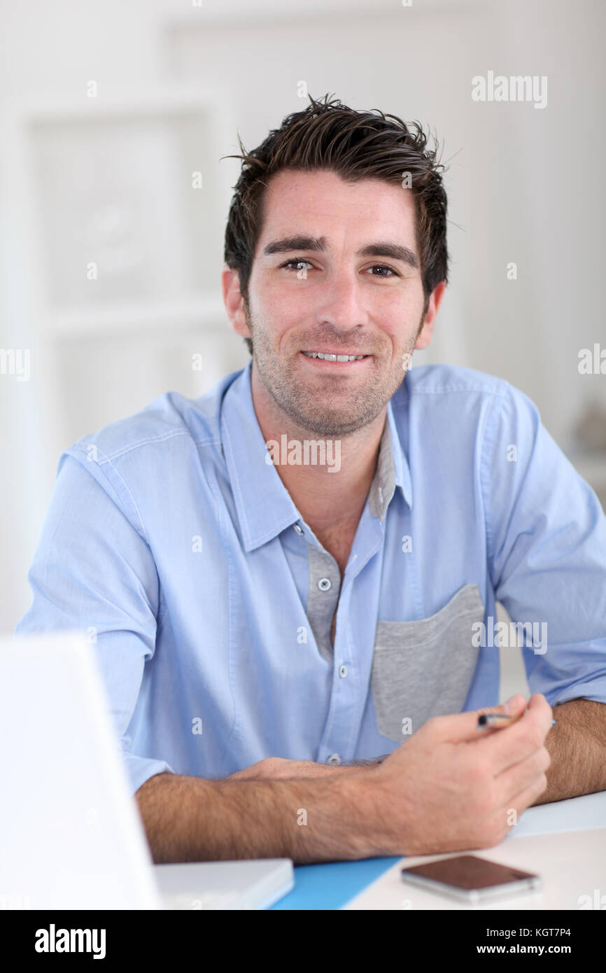 Smiling office worker at work Stock Photo - Alamy