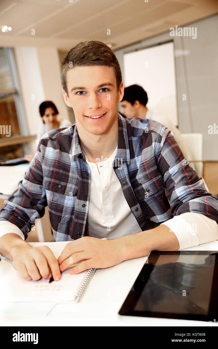 Teen boy writing classroom hi-res stock photography and images - Alamy