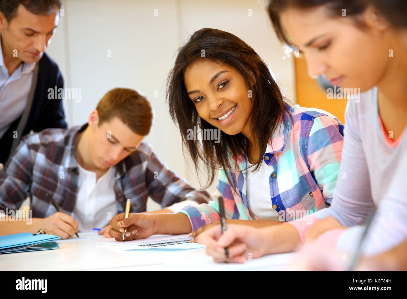 Group of teenagers in class writing an exam Stock Photo - Alamy