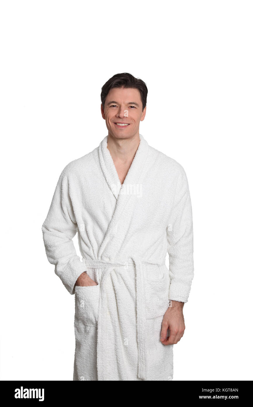 Adult man in bathrobe standing on white background Stock Photo - Alamy