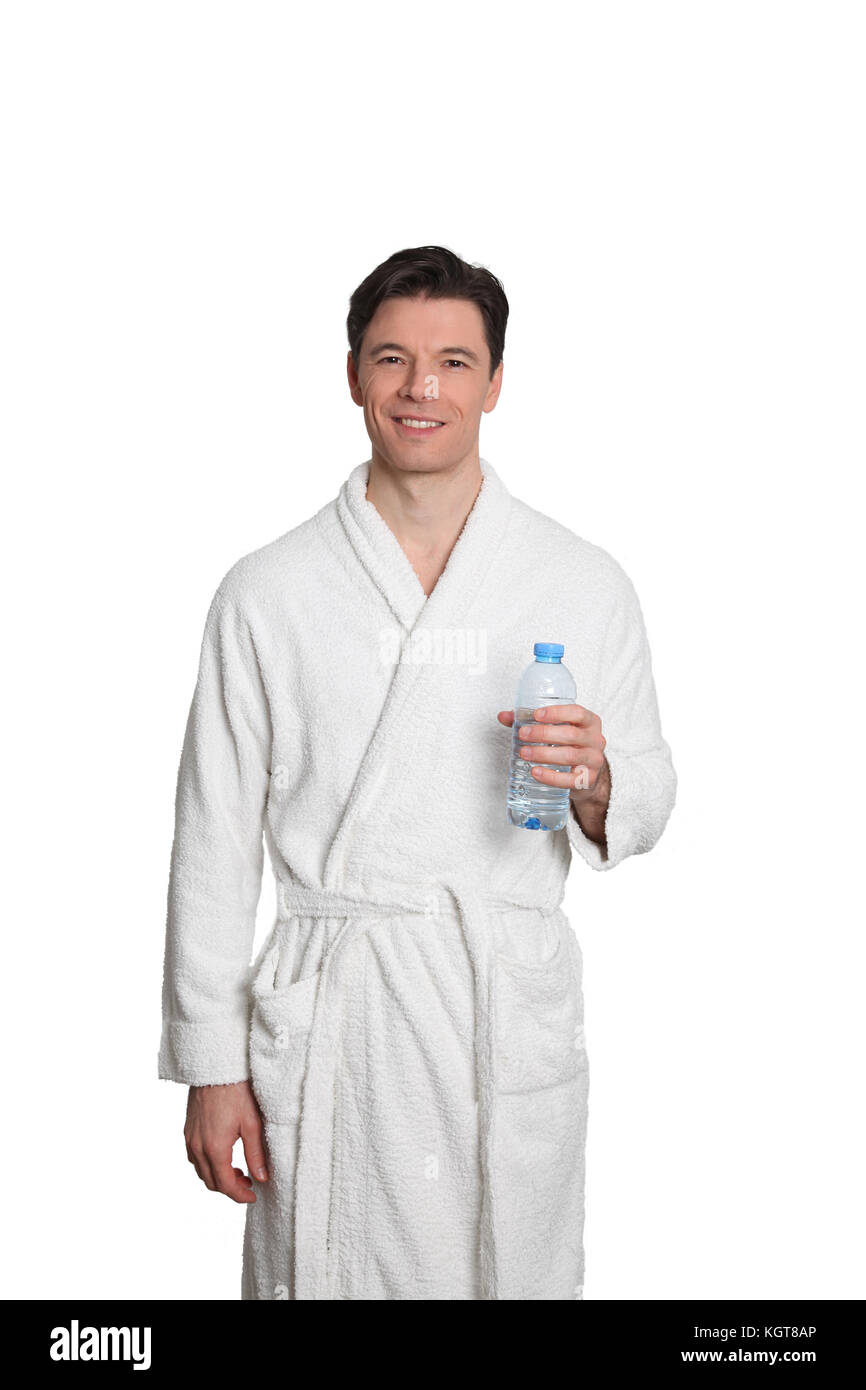 Adult man in bathrobe standing on white background Stock Photo - Alamy