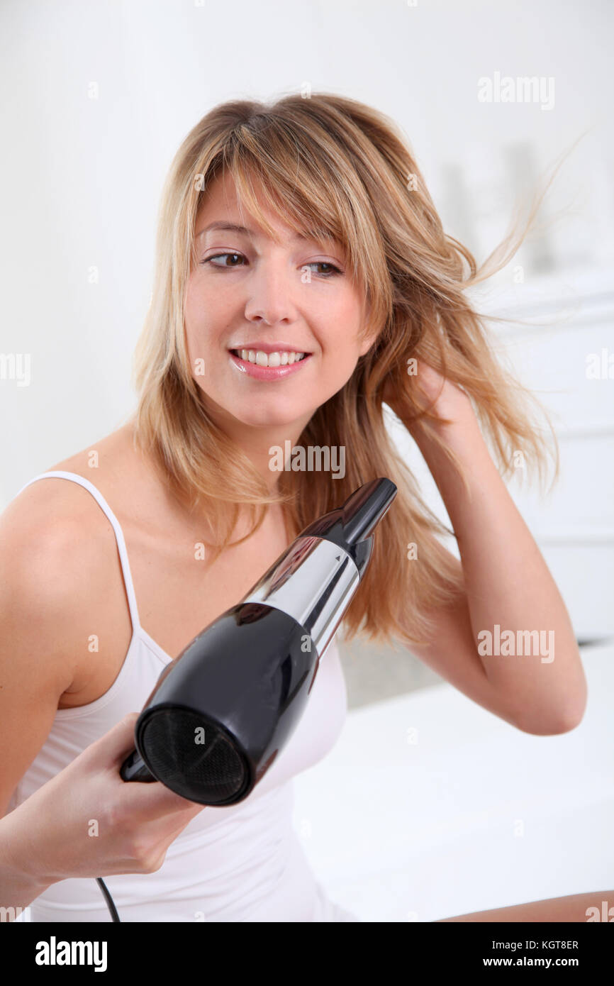 Beautiful woman drying her hair Stock Photo - Alamy