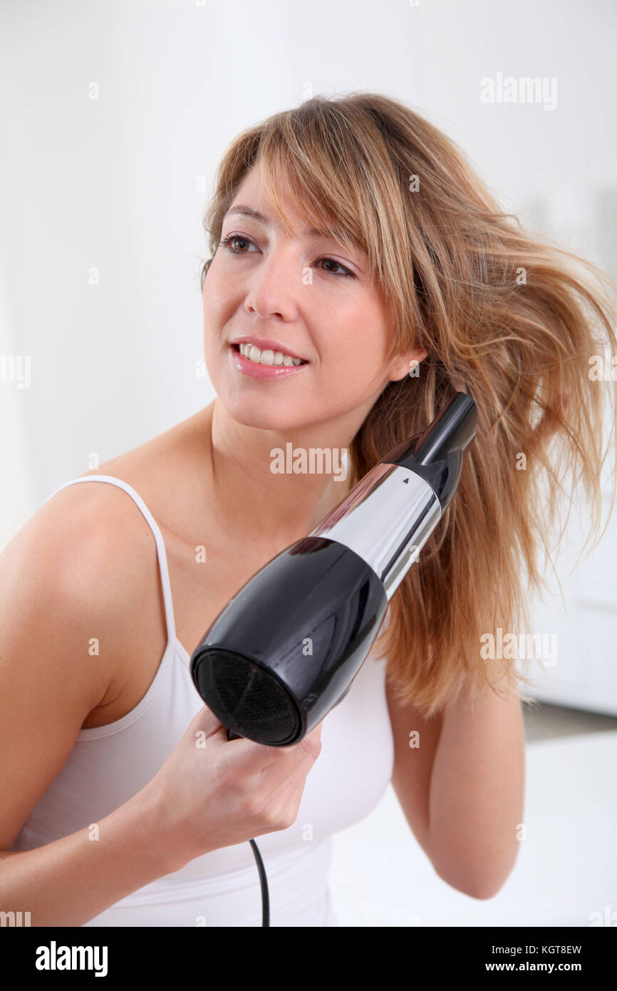 Beautiful woman drying her hair Stock Photo - Alamy