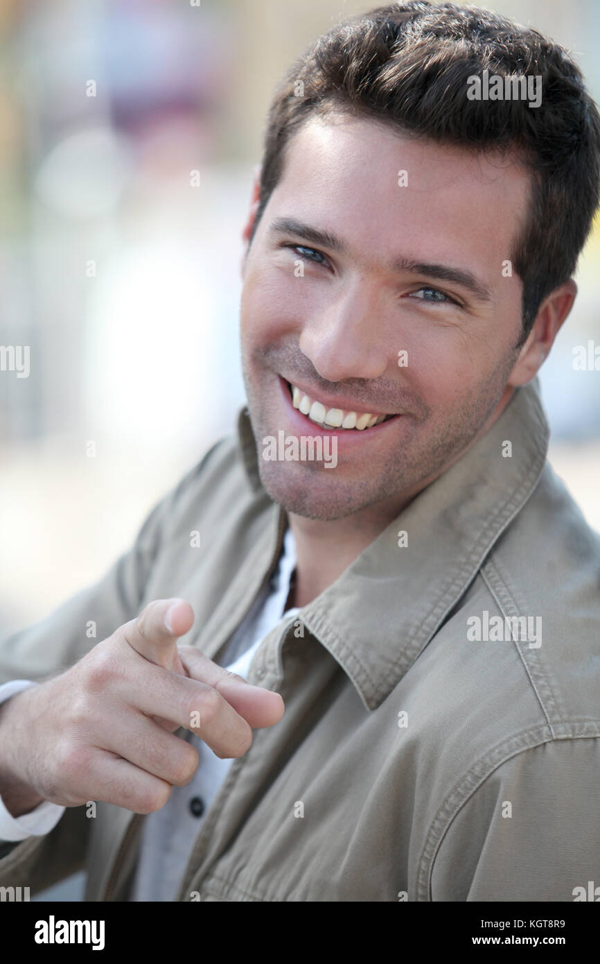 Portrait of handsome man pointing at camera Stock Photo - Alamy