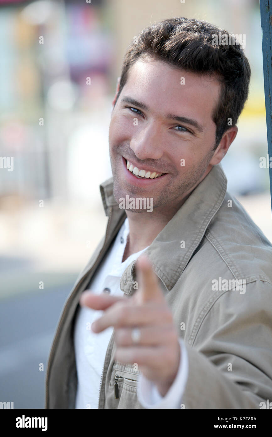 Portrait of handsome man pointing at camera Stock Photo - Alamy