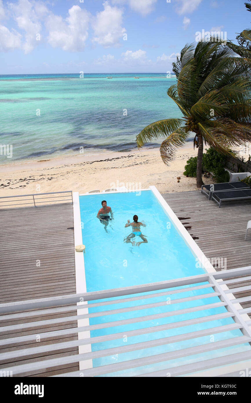 Upper view of couple swimming in infinity pool Stock Photo - Alamy