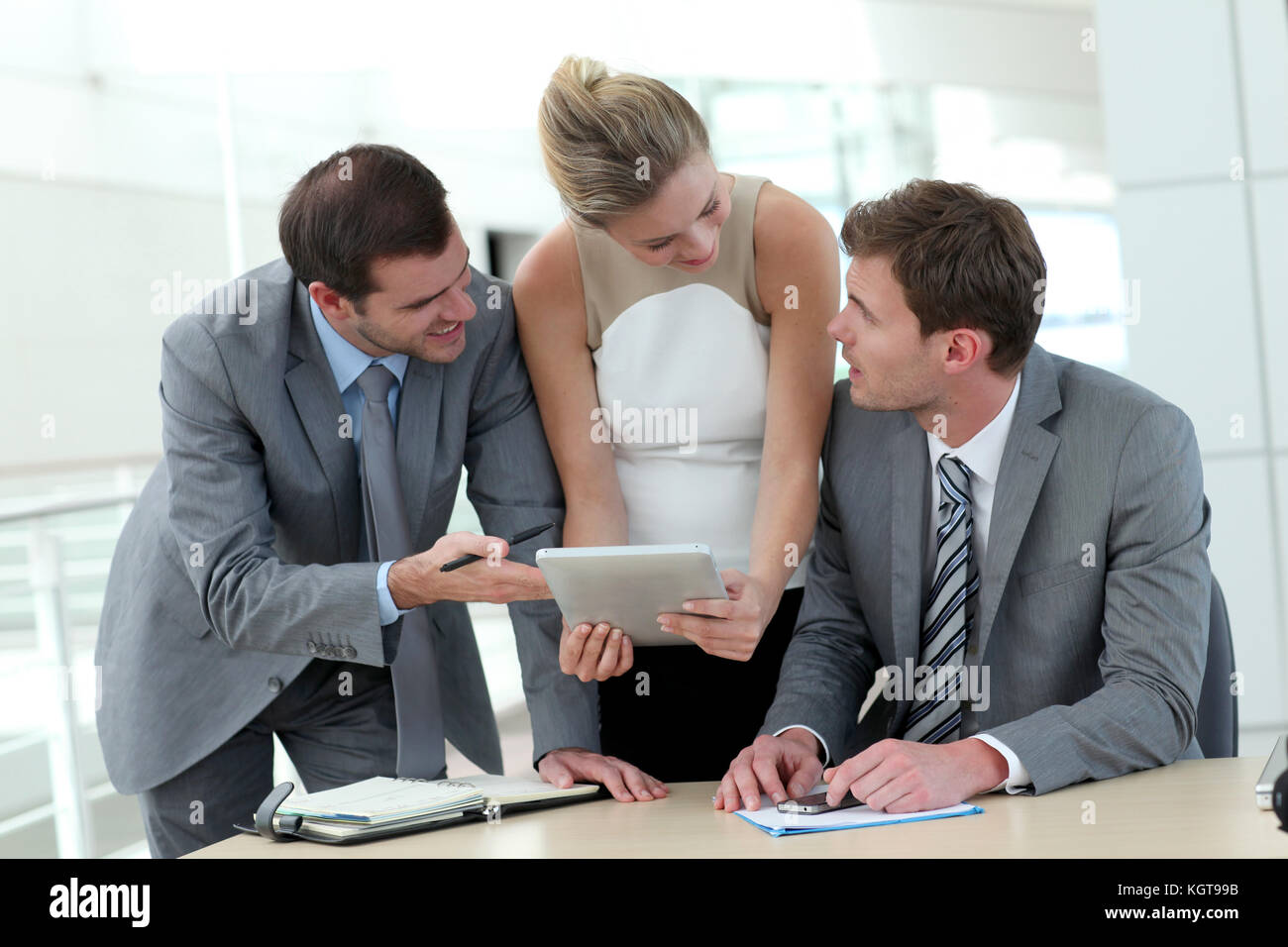 Group of business people meeting around table Stock Photo - Alamy