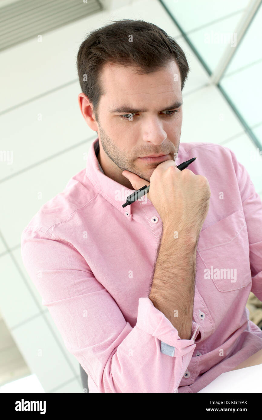 Office worker with thoughtful look Stock Photo - Alamy