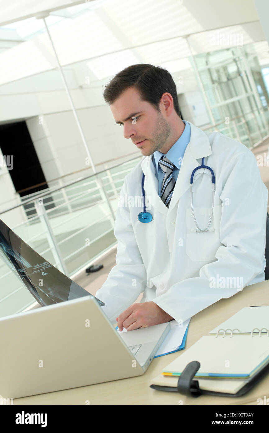Doctor in hospital looking at radiography Stock Photo - Alamy