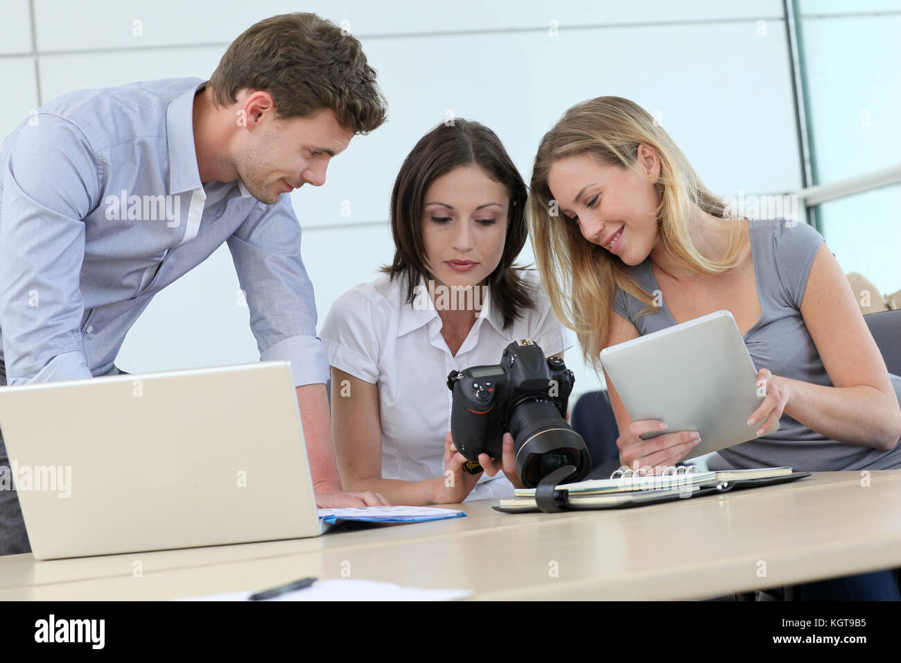 Team of photo reporters working in office Stock Photo - Alamy