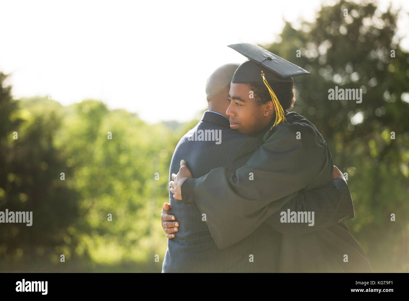 Father hugging his son at his graduation Stock Photo - Alamy