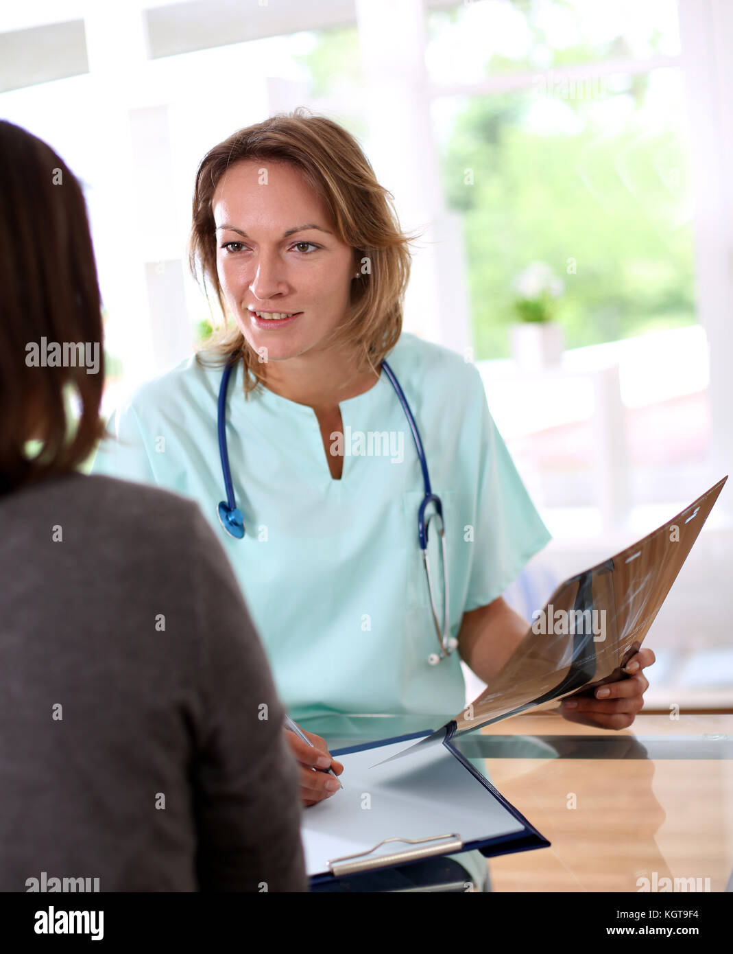 Nurse with patient in check-up room Stock Photo - Alamy