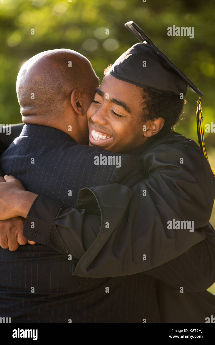 Father hugging his son at his graduation Stock Photo - Alamy