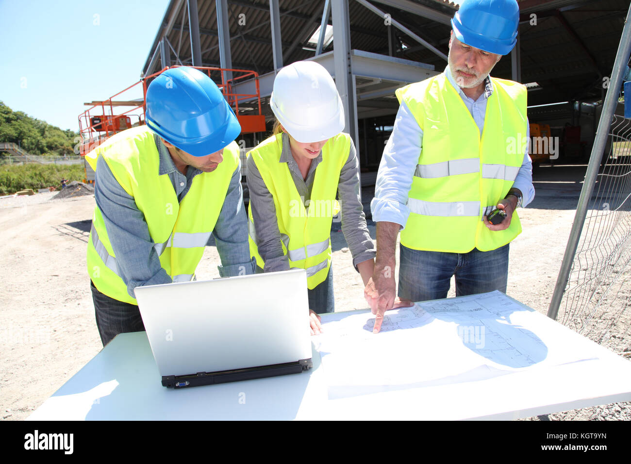 Industrial people working on building site Stock Photo - Alamy