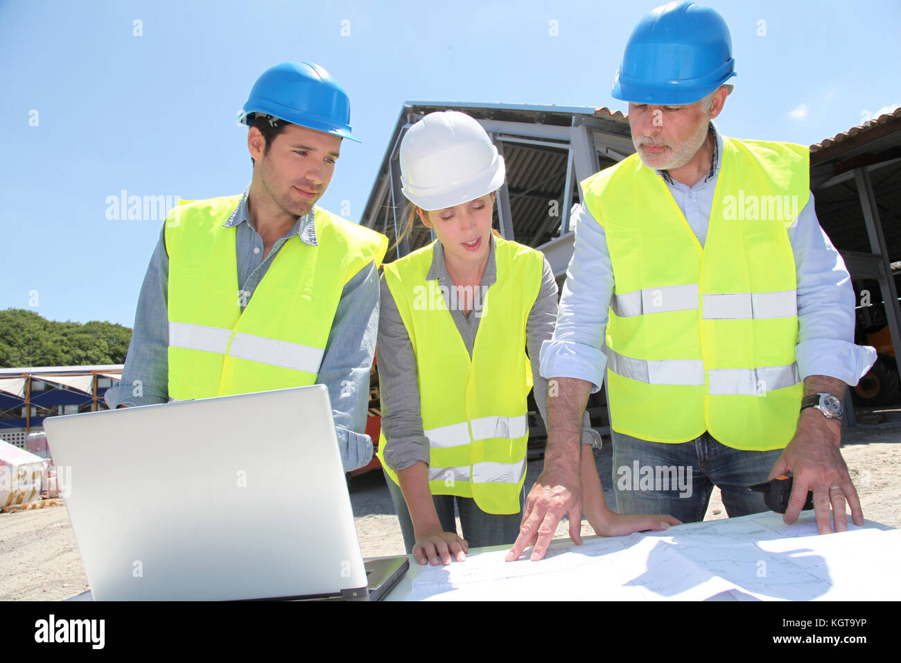 Industrial people working on building site Stock Photo - Alamy