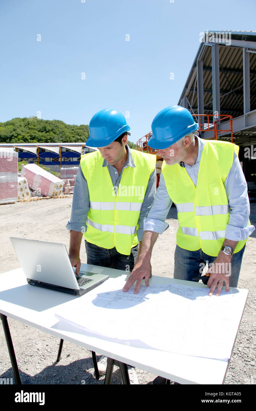 Industrial people working on building site Stock Photo - Alamy