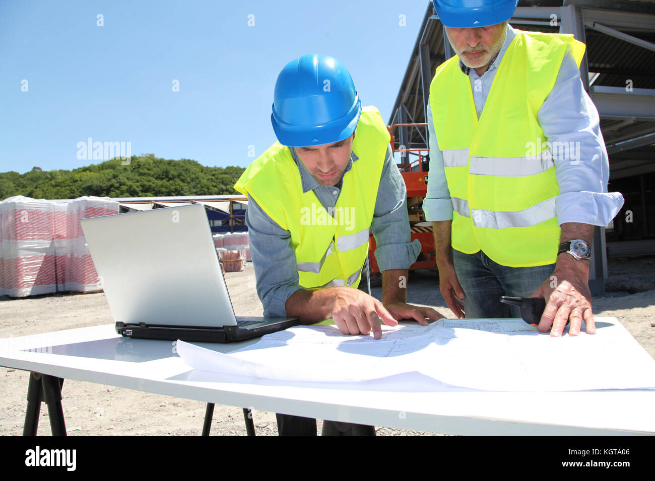 Industrial people working on building site Stock Photo - Alamy