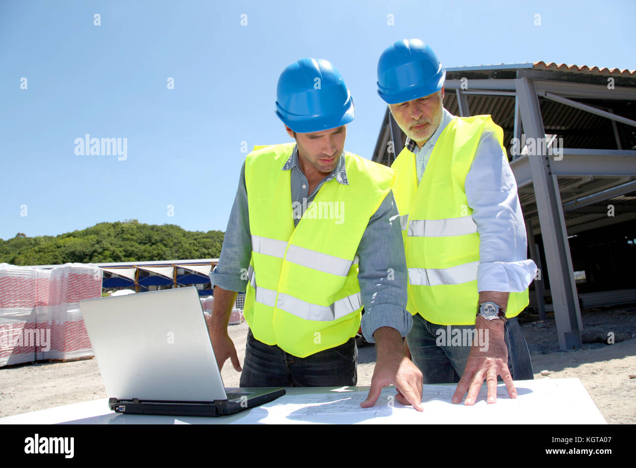 Industrial people working on building site Stock Photo - Alamy